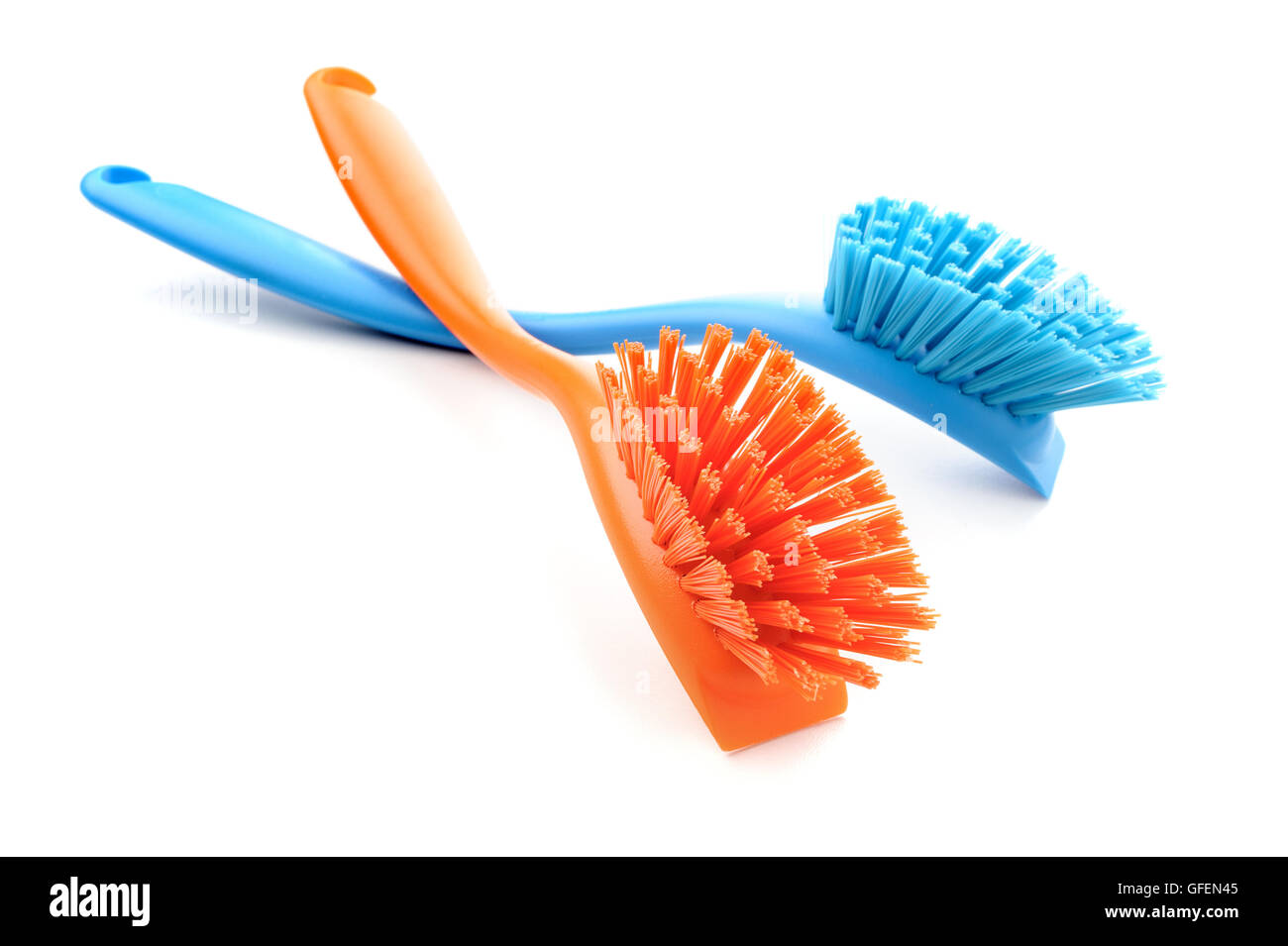 closeup blue and orange plastic cleaning brushes on white background ...