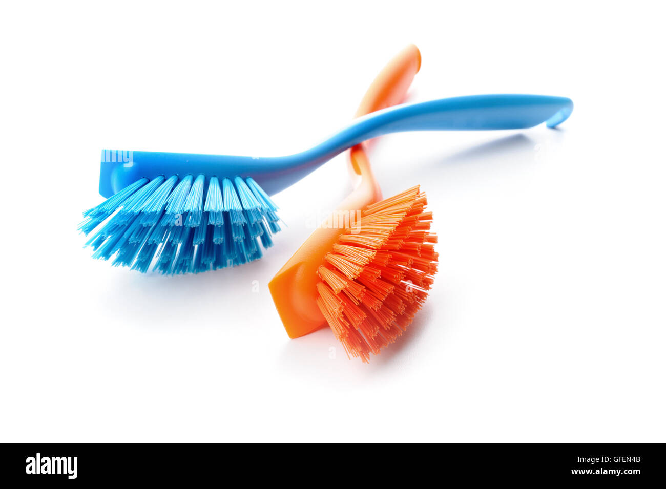 closeup blue and orange plastic cleaning brushes on white background ...