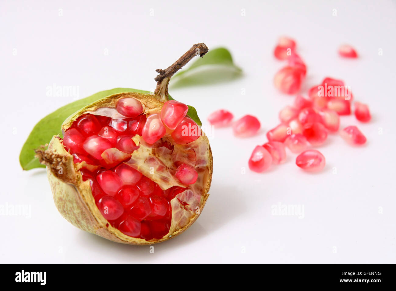 Open Pomegranate with seeds on white background Stock Photo - Alamy