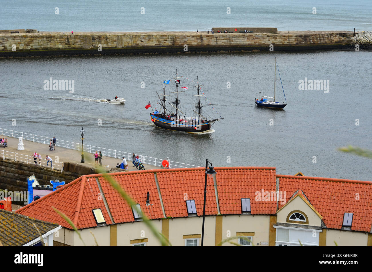 A view of Whitby Pier and harbour looking across rooftops in The North ...