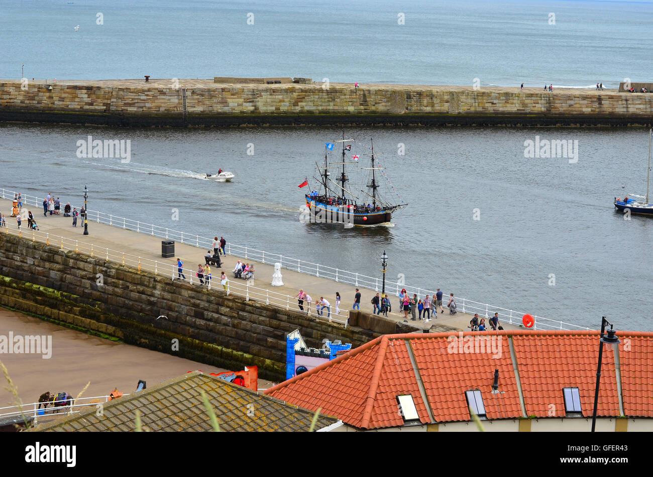 A view of Whitby Pier and harbour looking across rooftops in The North ...