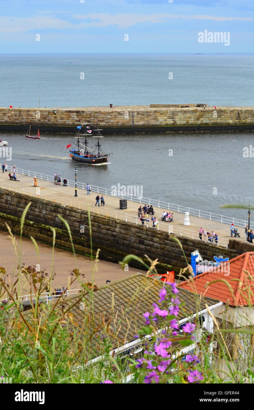 A view of Whitby Pier and harbour looking across rooftops in The North ...