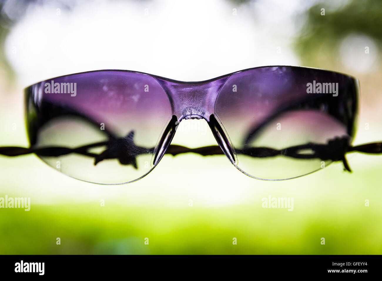 Stylish Sunglasses kept outdoor on the Iron bar or Fence Stock Photo ...