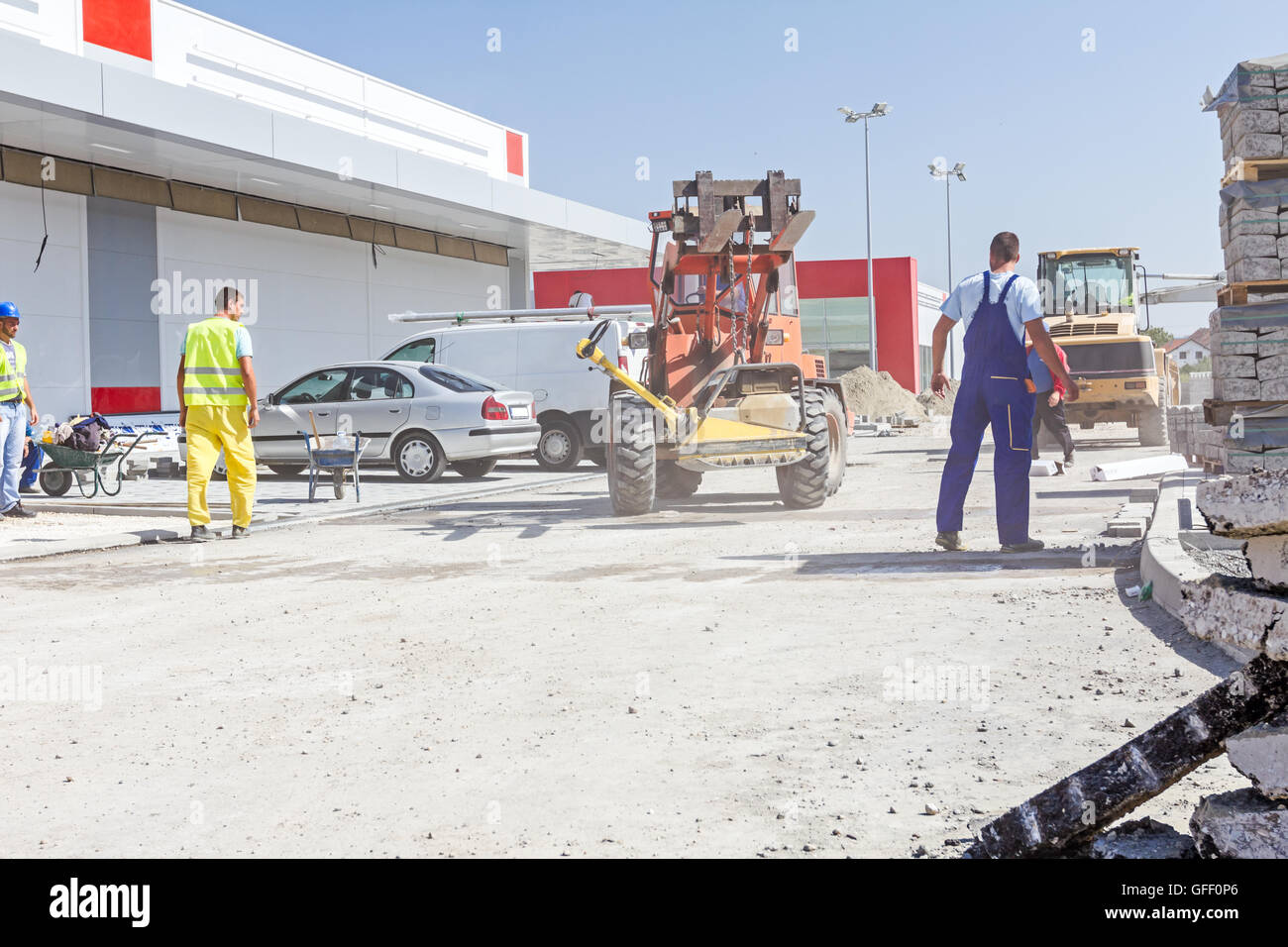 View on construction site with machinery, people at work. Landscape ...