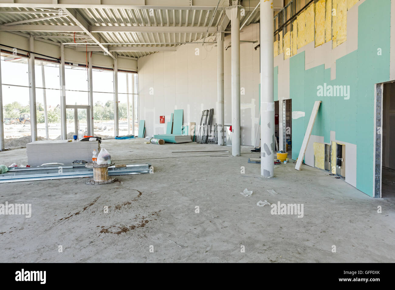 View on indoor construction site of unfinished modern large showroom ...