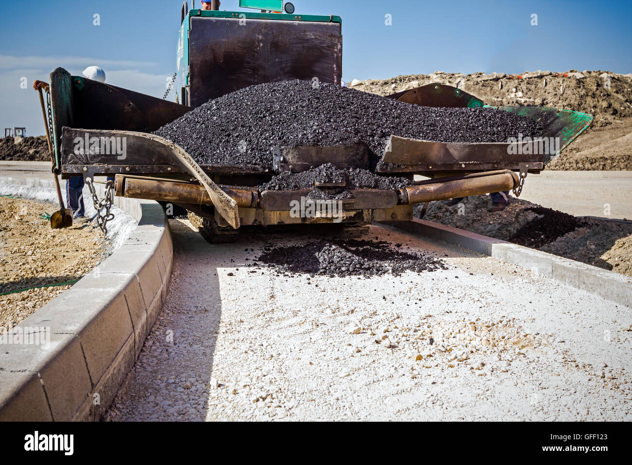 Front view on asphalt laying machine full of fresh asphalt at road ...