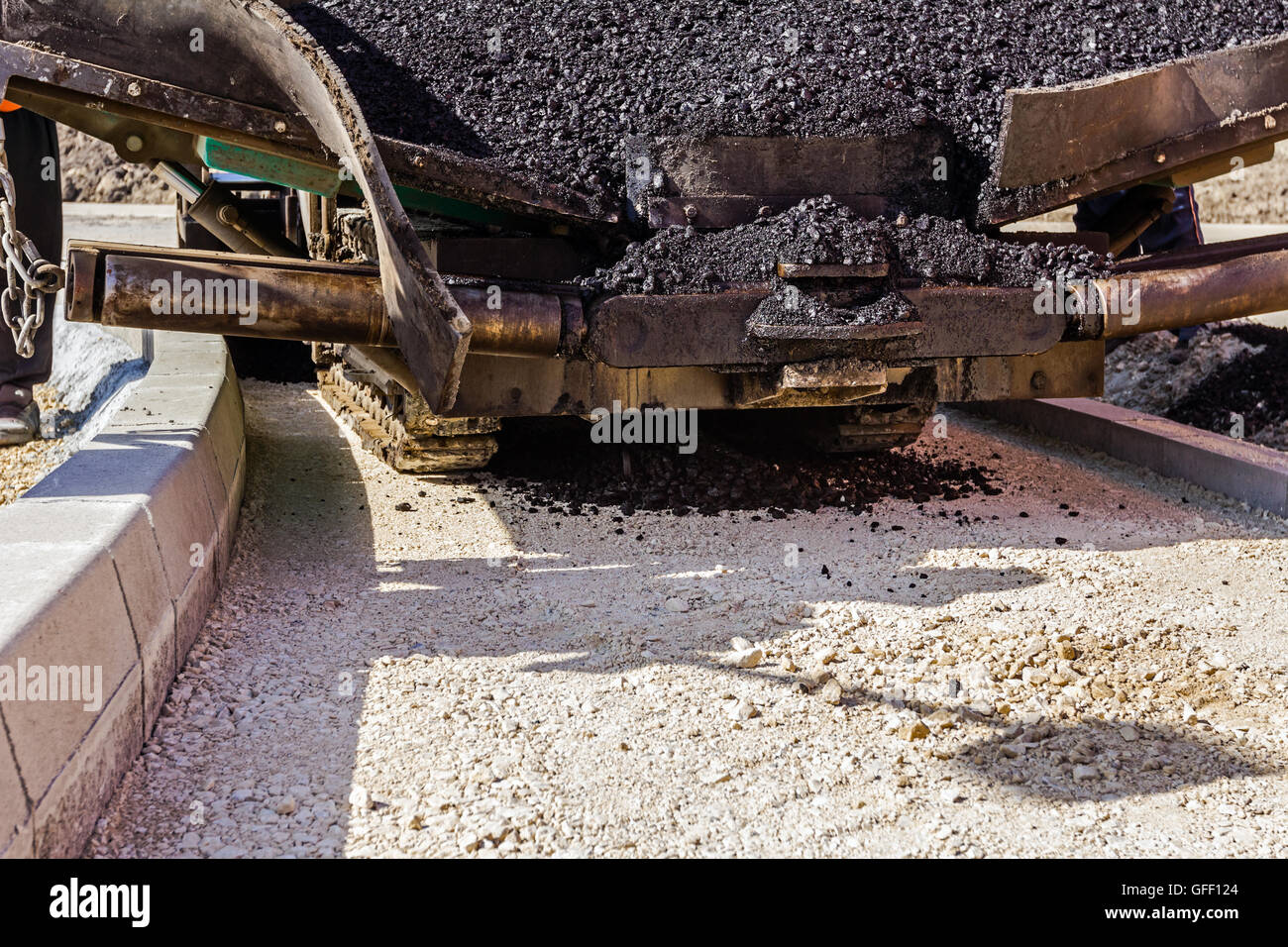 Front view on asphalt laying machine full of fresh asphalt at road ...