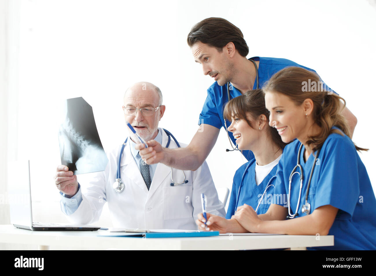 Medical team checking on X-ray results isolated on white Stock Photo ...