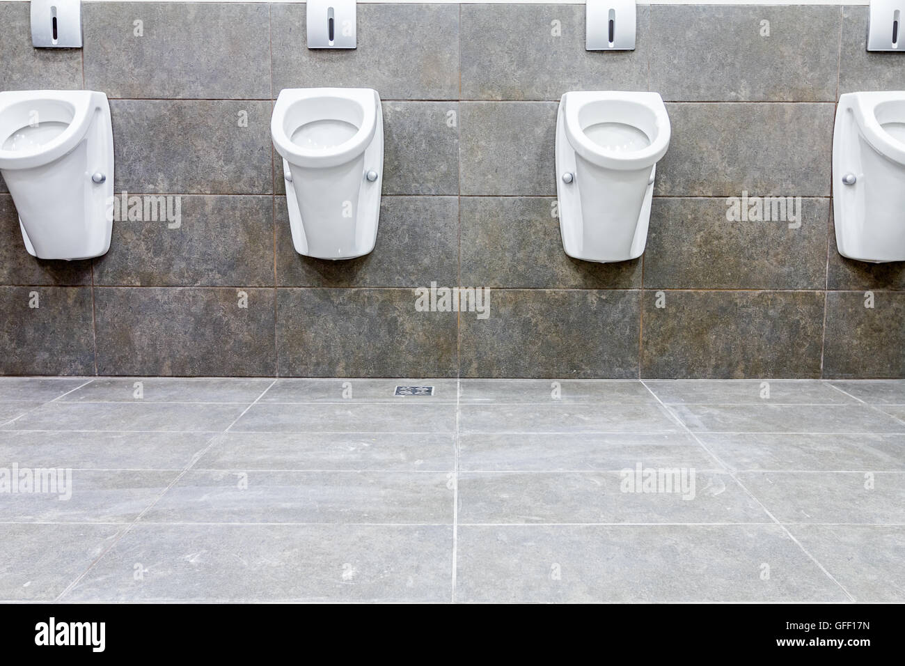 Modern designed of public toilet urinals lined up, no privacy Stock ...