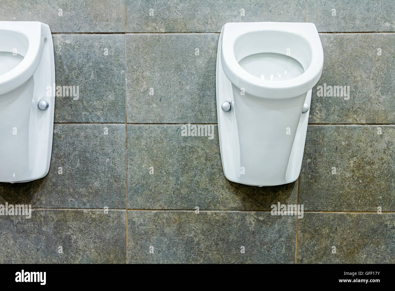 Modern designed of public toilet urinals lined up, no privacy Stock ...