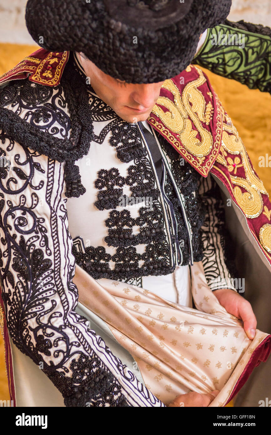Spainish bullfighter Miguel Abellan putting itself the walk cape in the ...