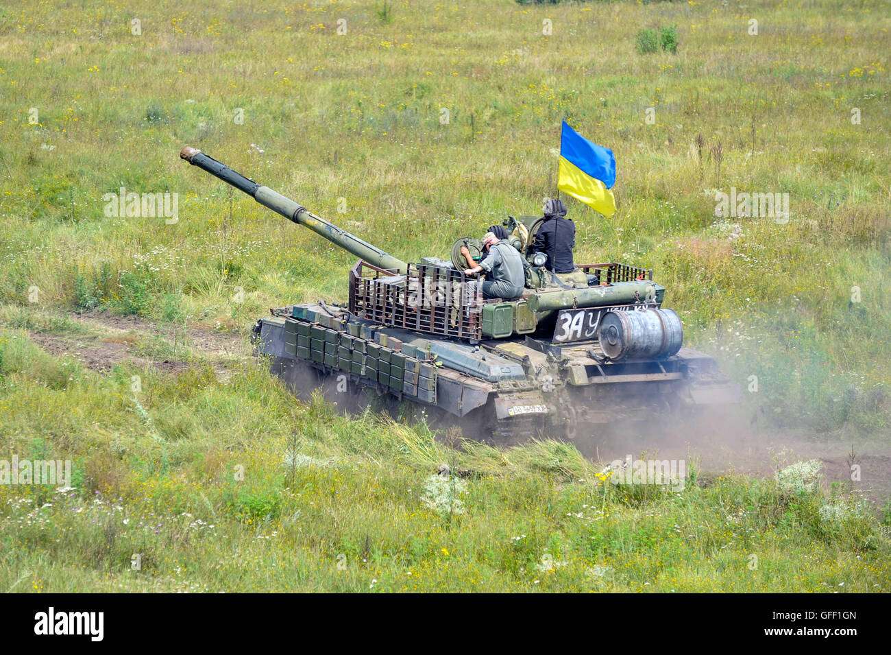 Main battle tank under the Ukrainian flag at a firing range in summer ...