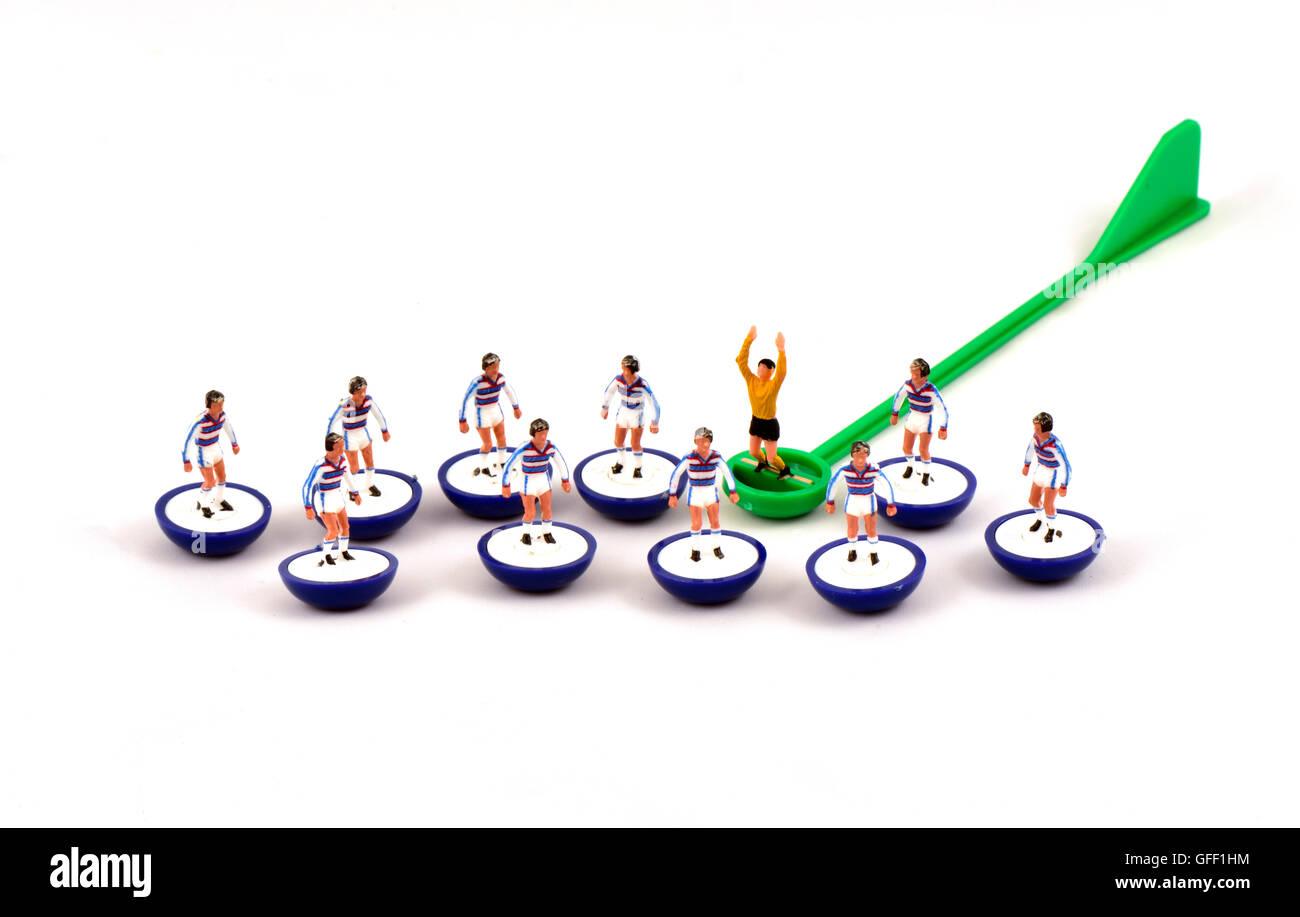 Subbuteo table football team players goalkeeper on a stick against a ...