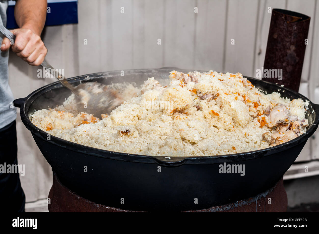 pilaf, rice with meat with a big pot Stock Photo - Alamy