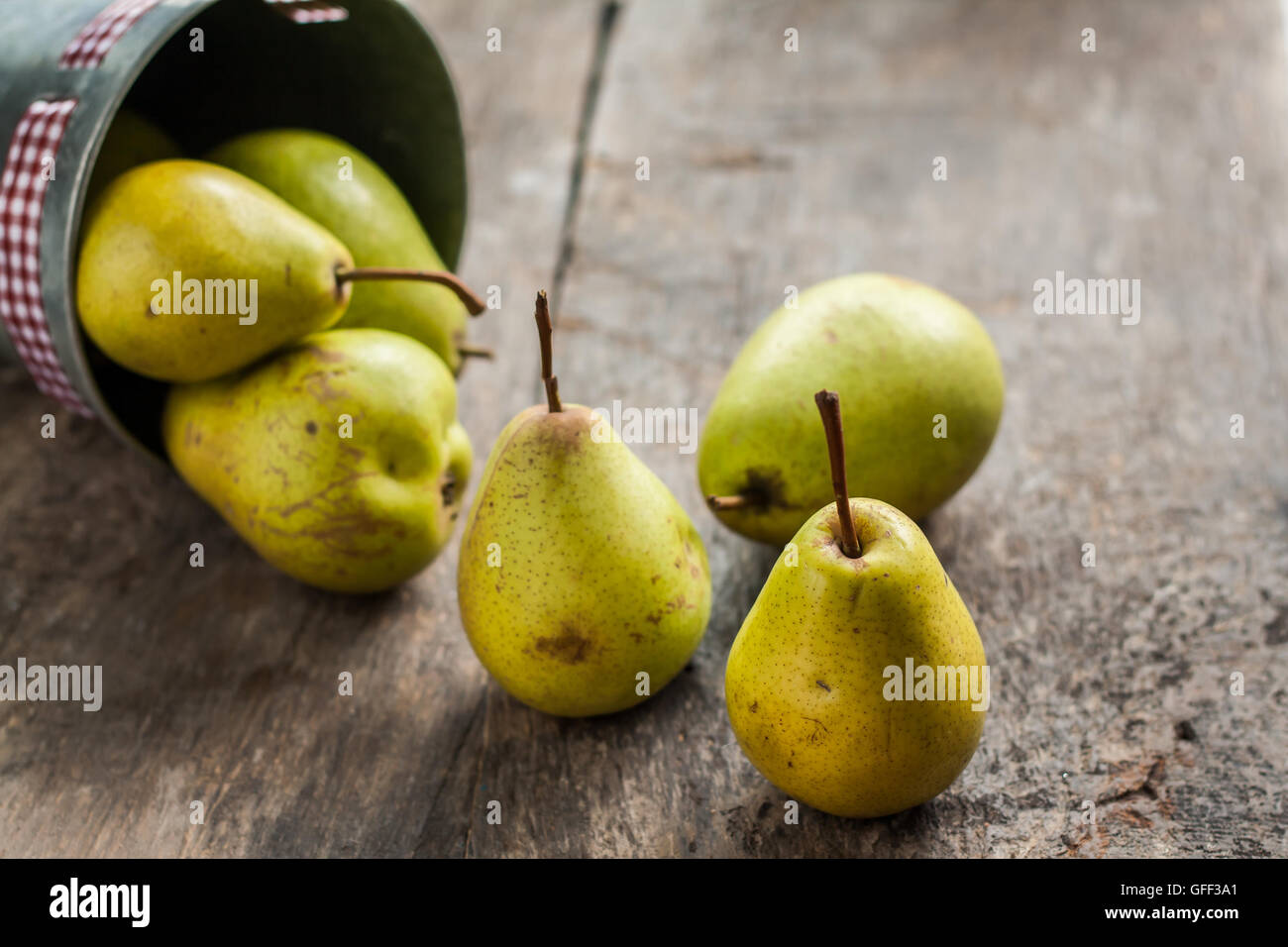 pears in a bucket on a rustic wooden table background Stock Photo - Alamy