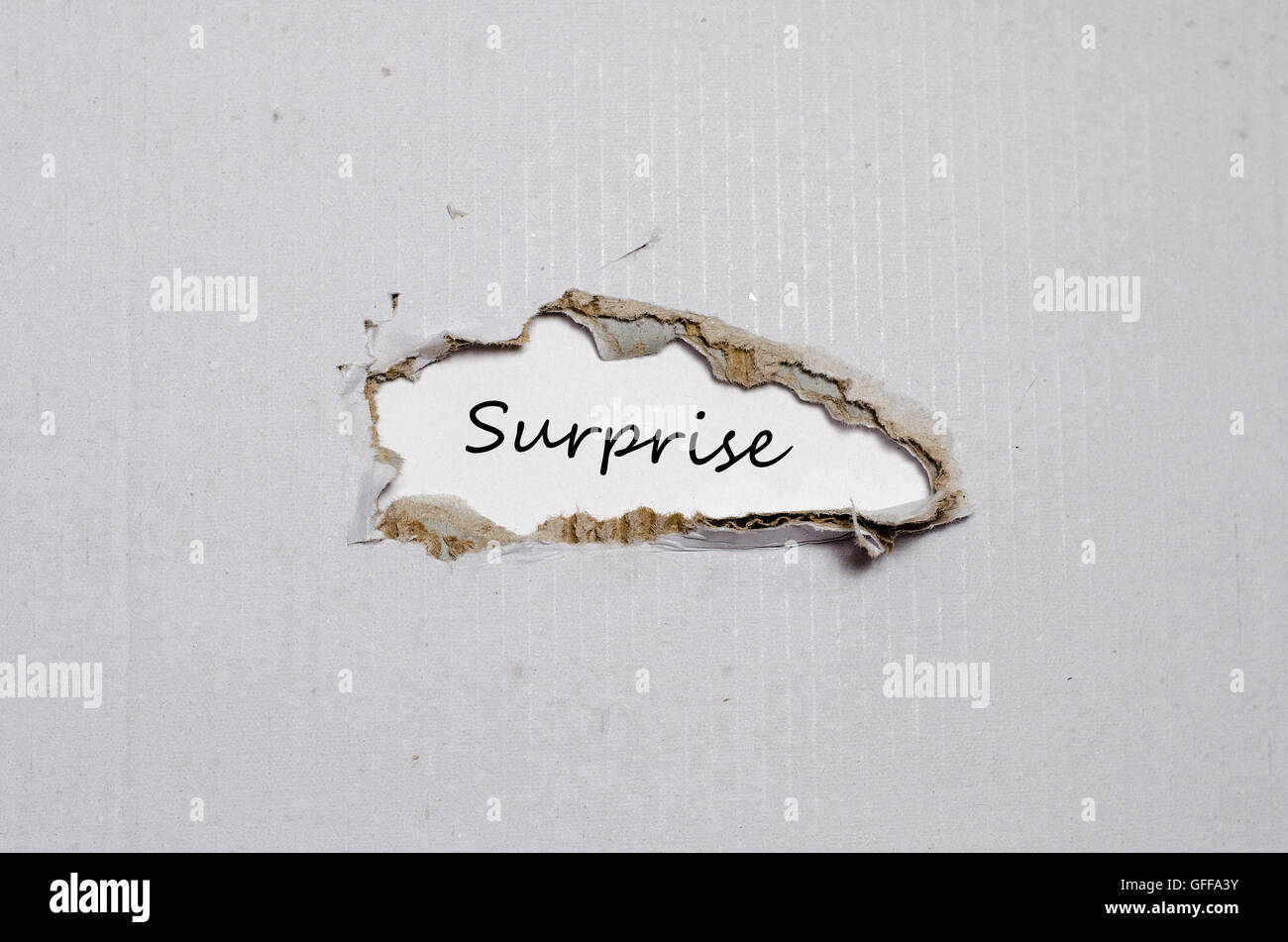 The word surprise appearing behind torn paper Stock Photo - Alamy