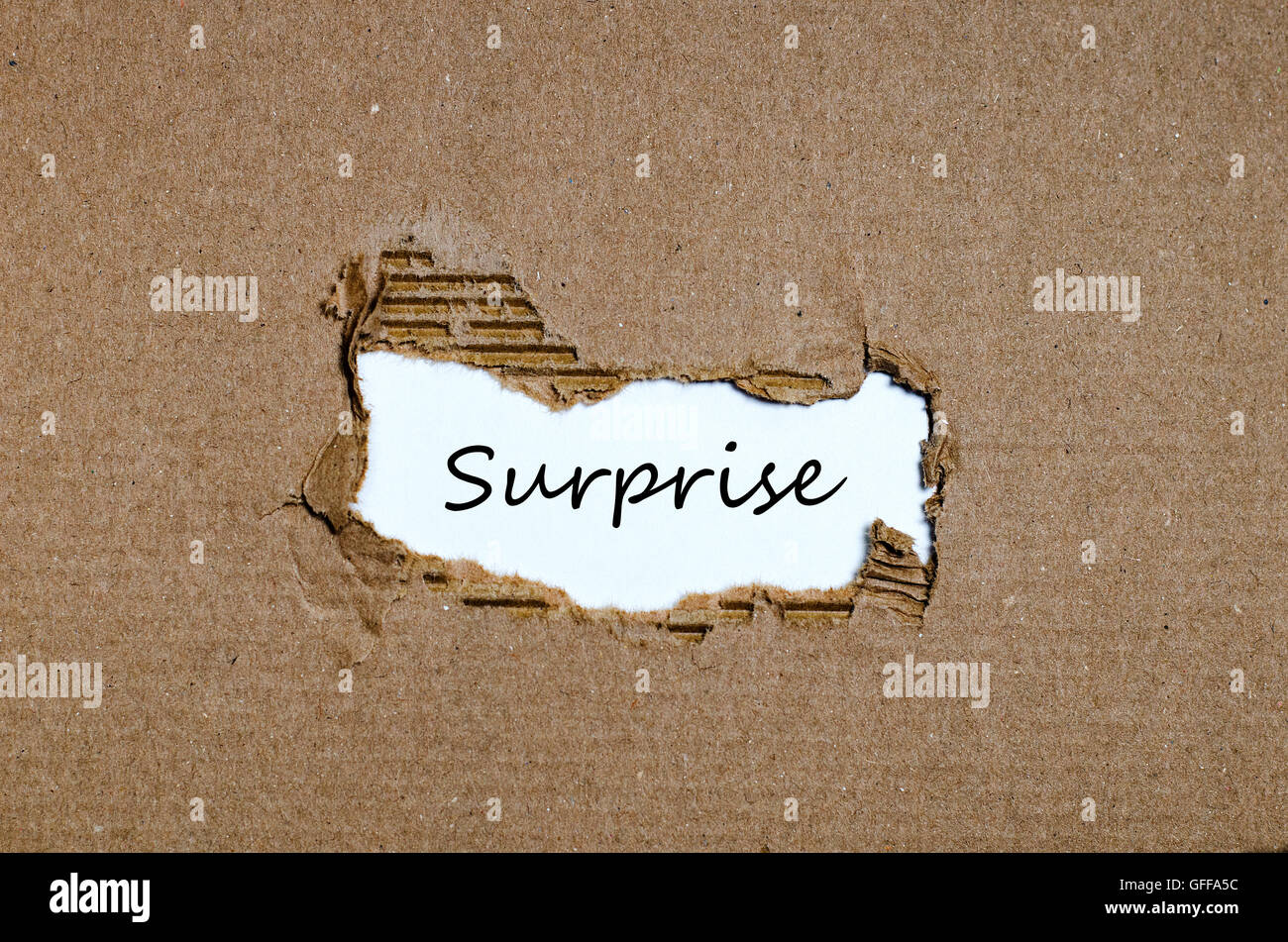 The word surprise appearing behind torn paper Stock Photo - Alamy