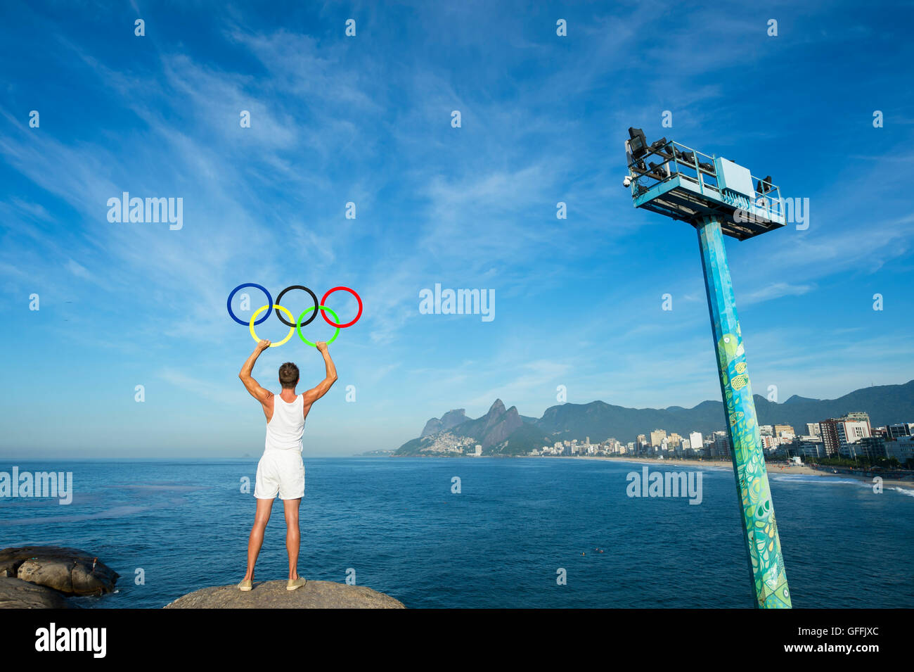 RIO DE JANEIRO - MARCH 27, 2016: Athlete holds Olympic rings standing ...