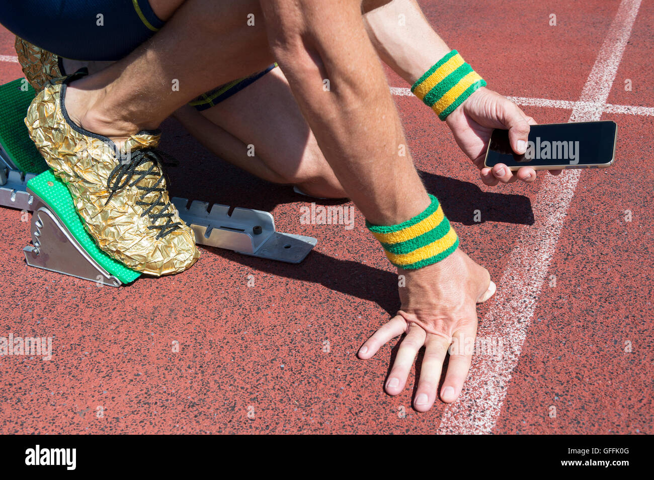 Brazilian athlete crouching at the starting line of a running track ...