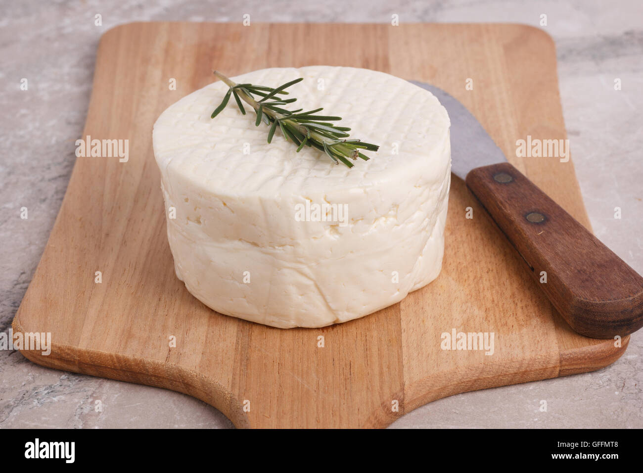 Wheel of brazilian traditional cheese Minas on wooden board. Selective ...