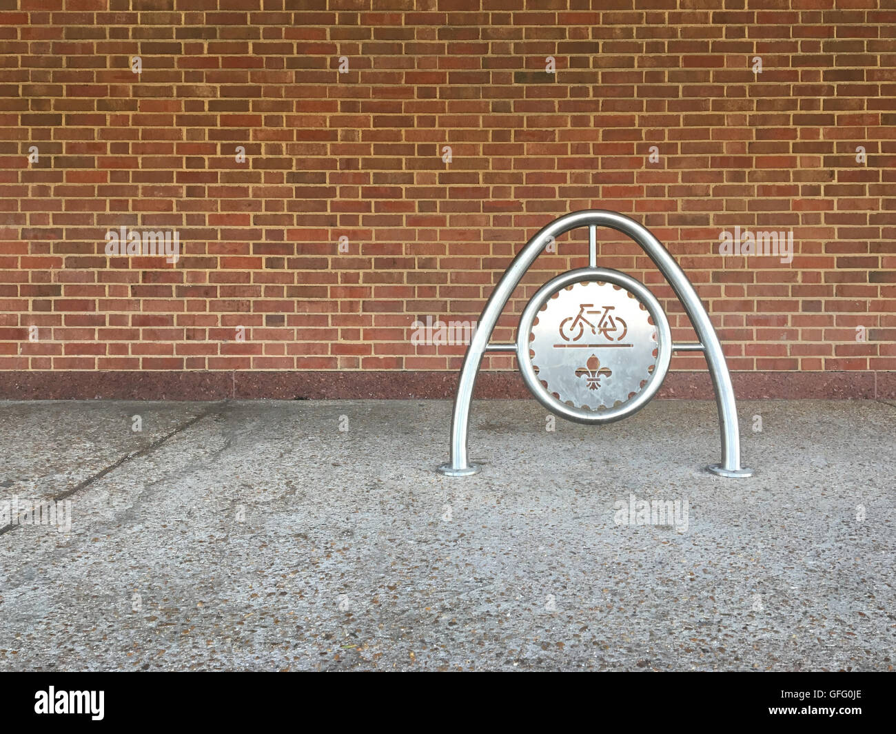 Stainless steel bike rack on a sidewalk by a brick wall Stock Photo - Alamy