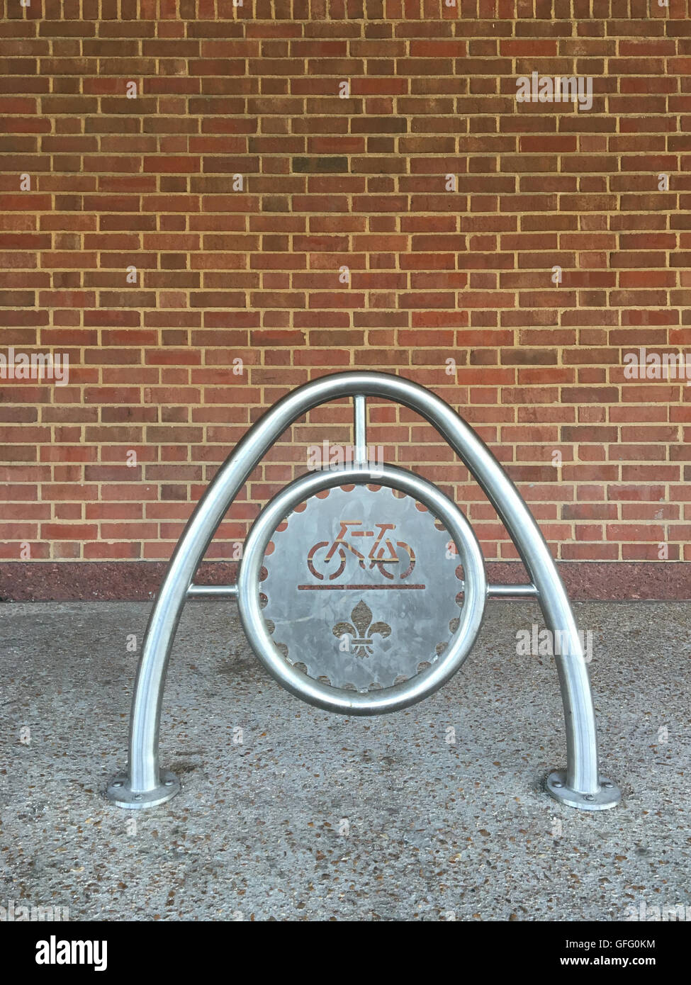 Stainless steel bike rack on a sidewalk by a brick wall Stock Photo - Alamy