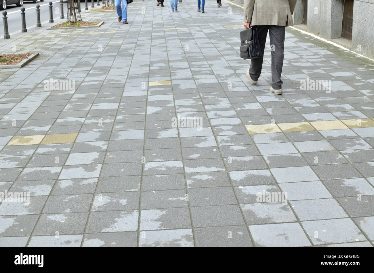 Passersby on a pavement in city center during day Stock Photo - Alamy