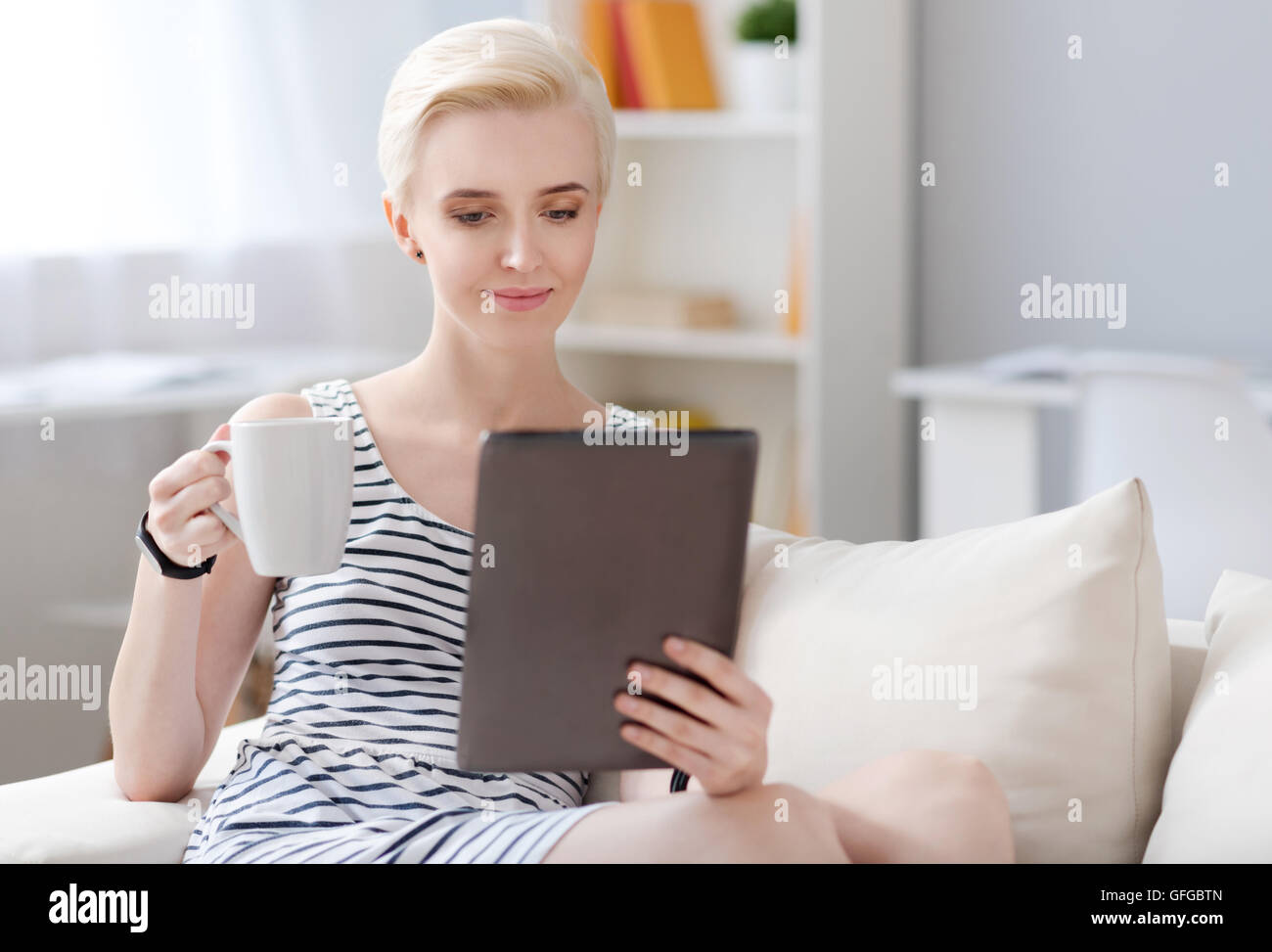 Woman looking at the tablet Stock Photo - Alamy