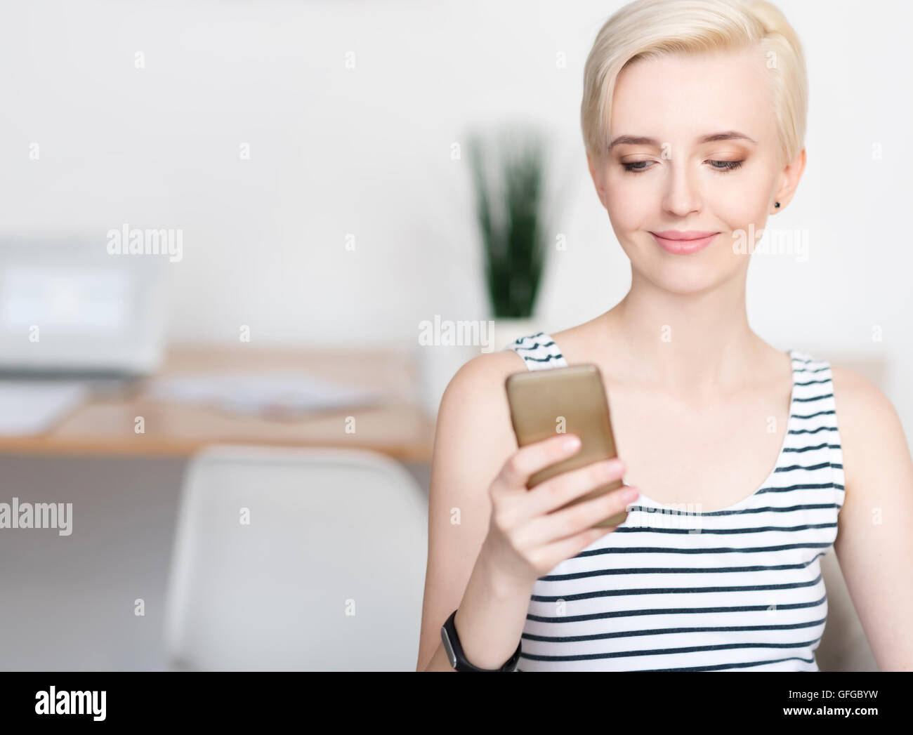 Woman looking at the phone Stock Photo - Alamy