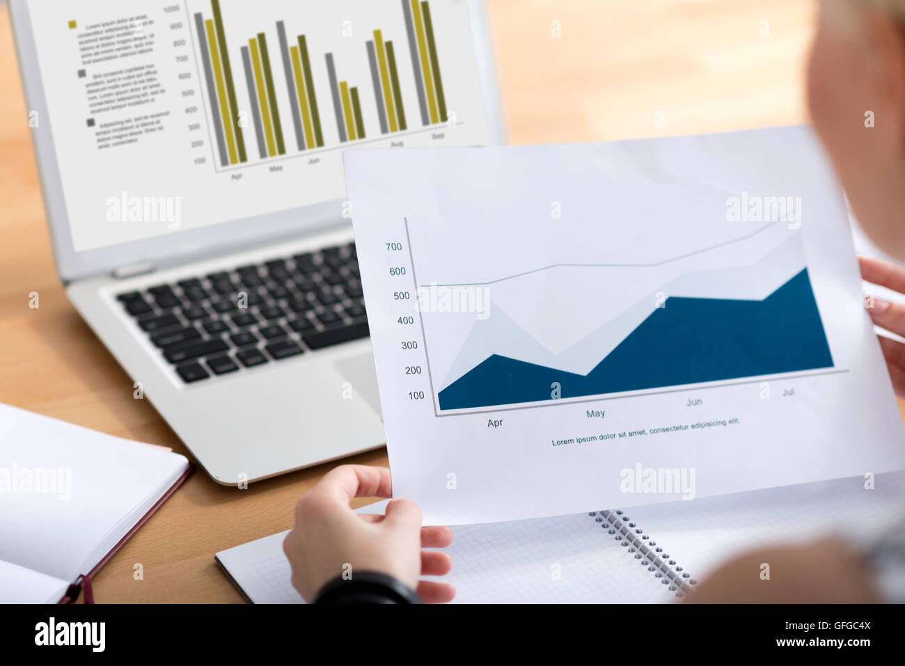 Hands holding paper with chart Stock Photo - Alamy