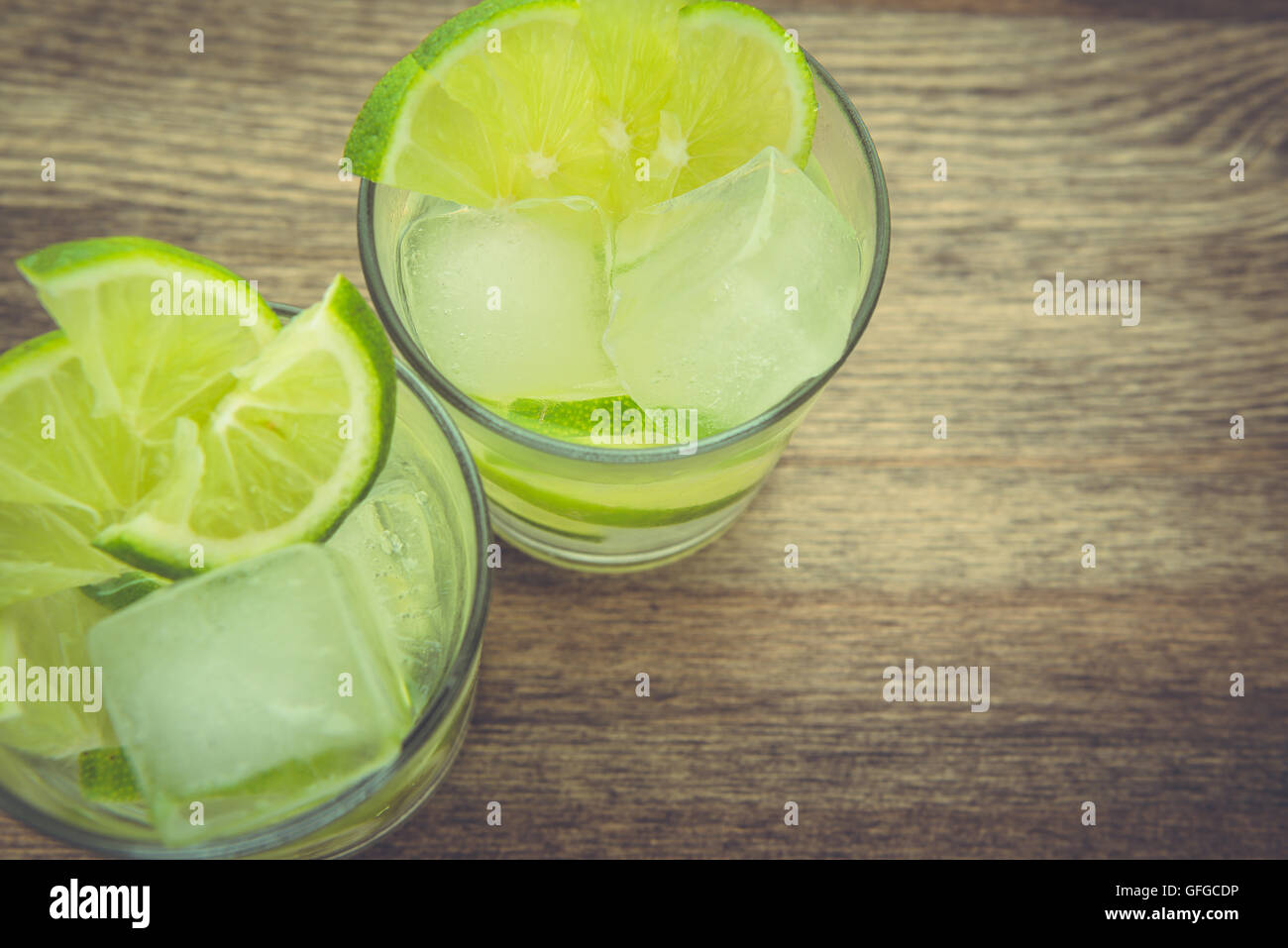 Still life of lime infused drinks on wood table top Stock Photo - Alamy