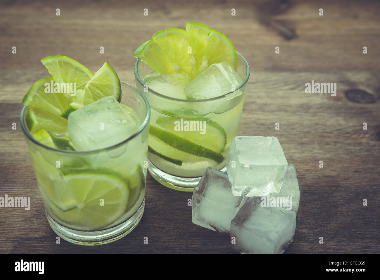 Still life of lime infused drinks on wood table top Stock Photo - Alamy