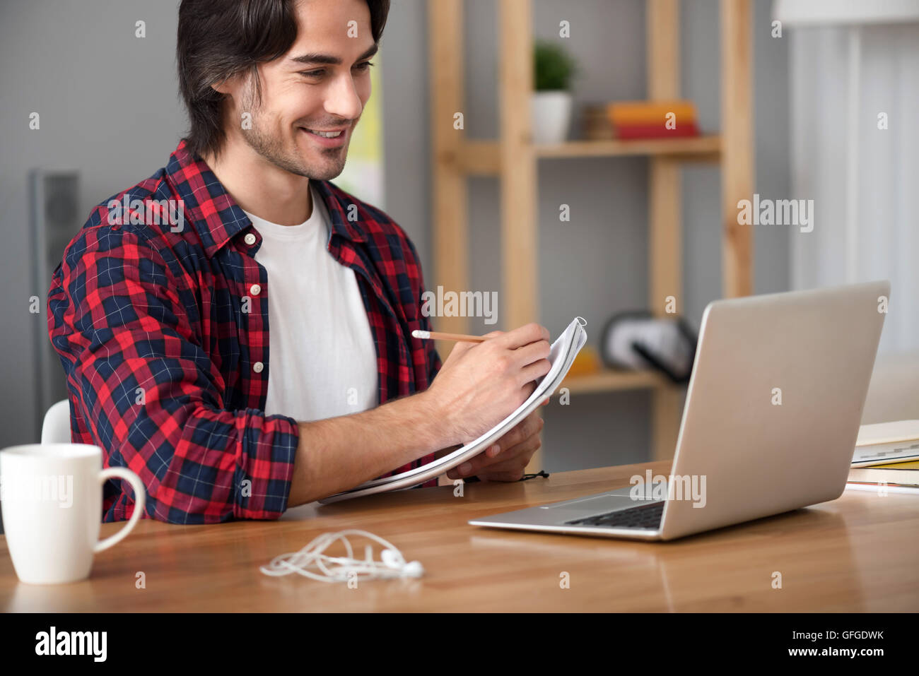 Positive handsome man making notes Stock Photo - Alamy