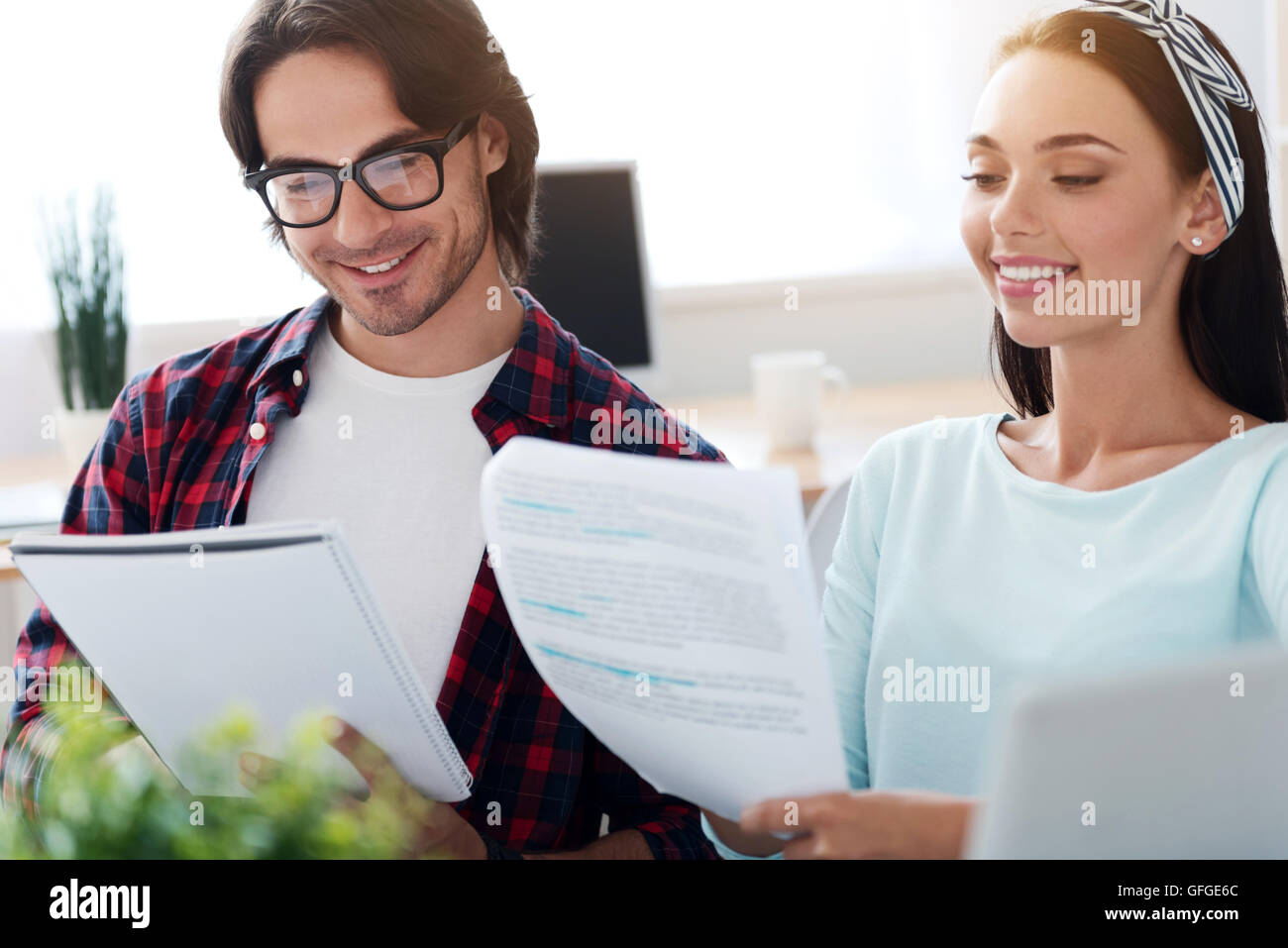 Delighted smiling colleagues working in the office Stock Photo - Alamy