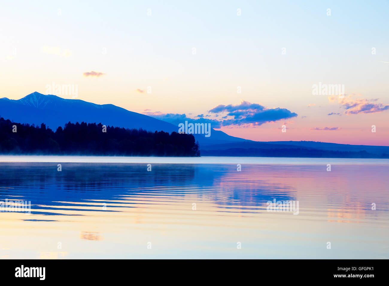 beautiful landscape with mountains and lake at dawn in golden, blue and ...