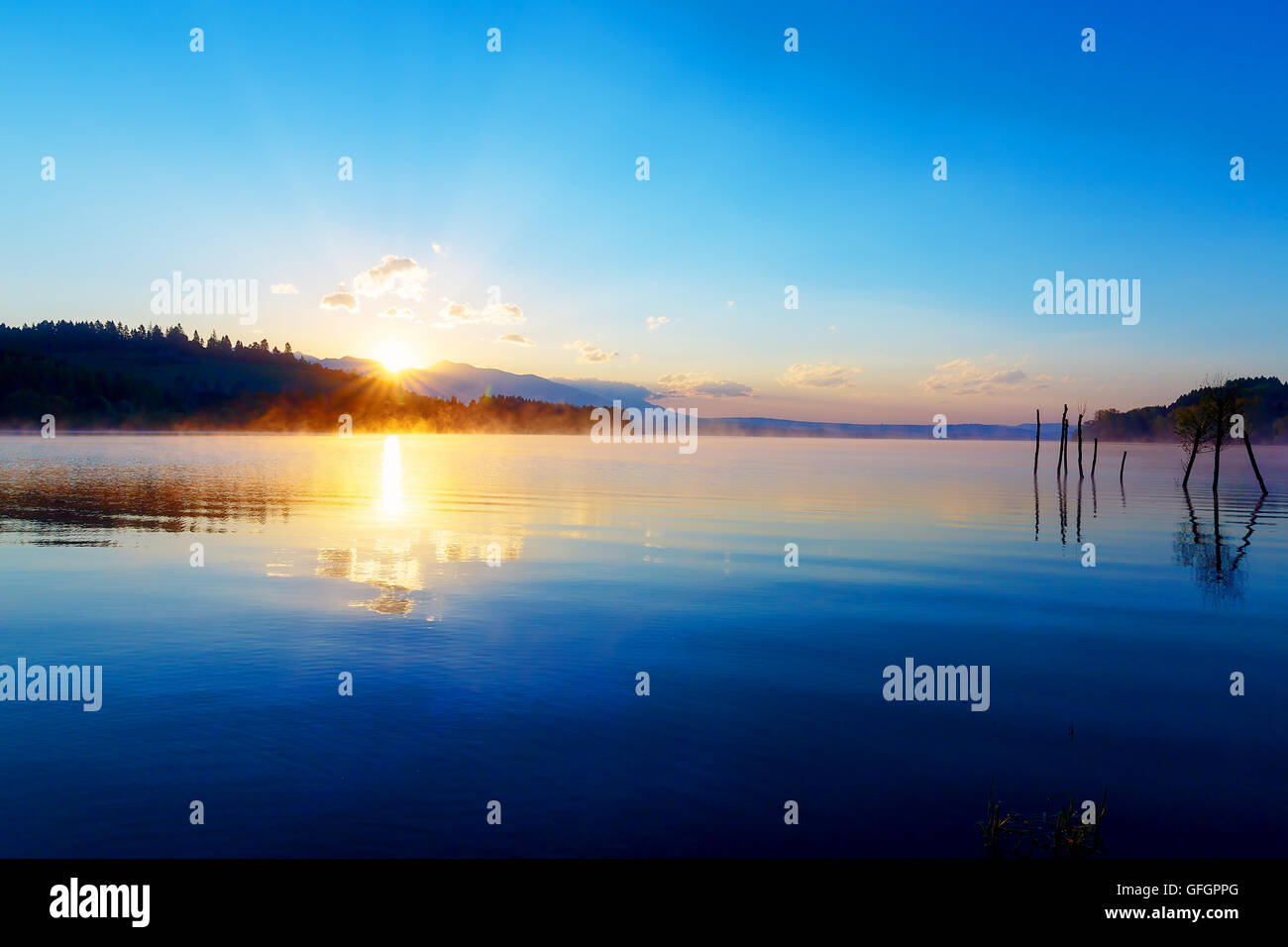 beautiful landscape with mountains and lake at dawn in golden, blue and ...