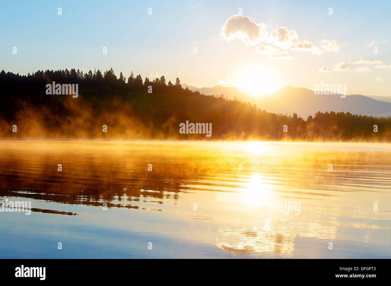 beautiful landscape with mountains and lake at dawn in golden blue and ...