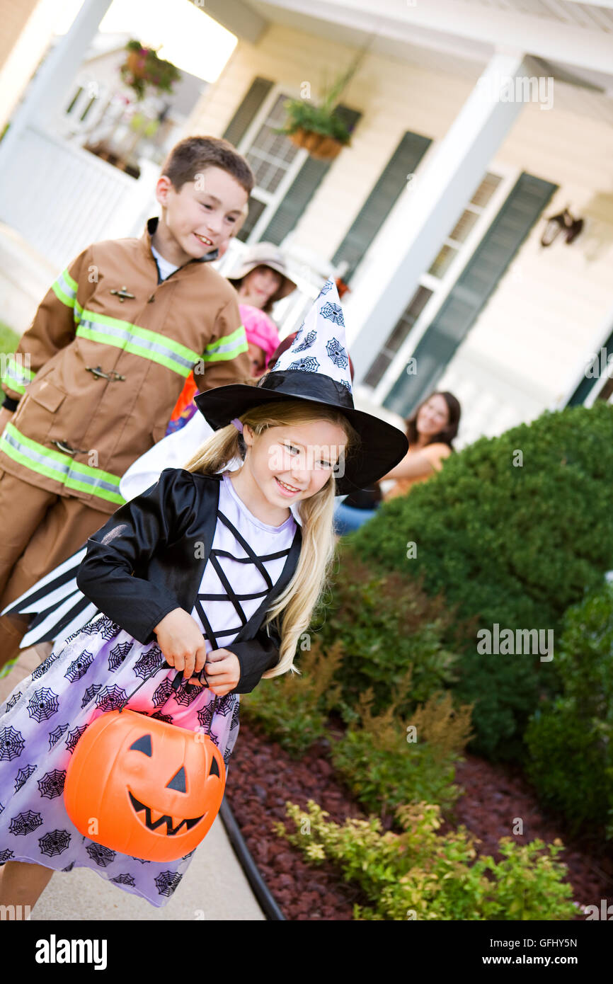 Group of neighborhood children on Halloween, having fun in costume ...