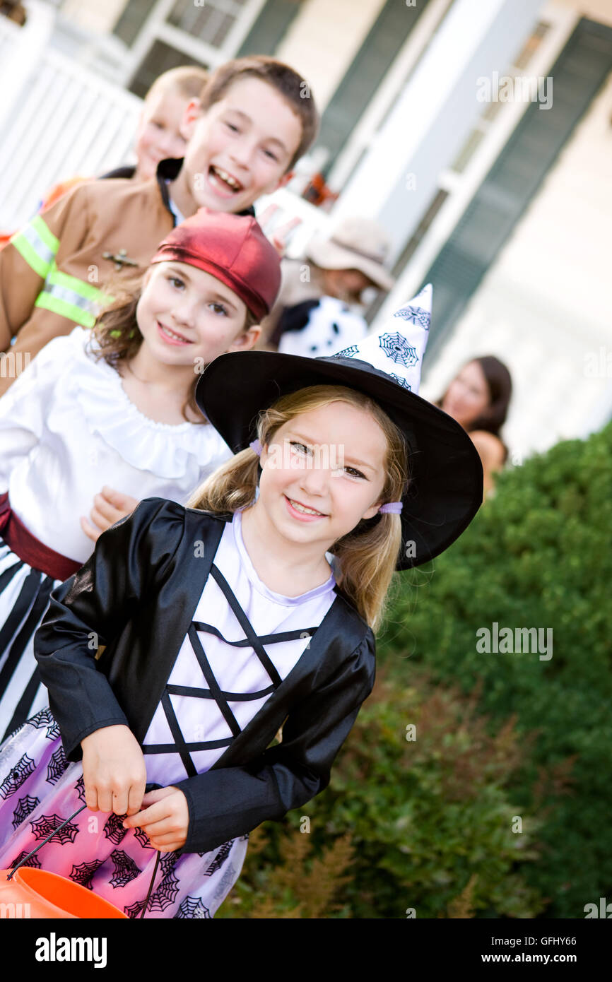 Group of neighborhood children on Halloween, having fun in costume ...