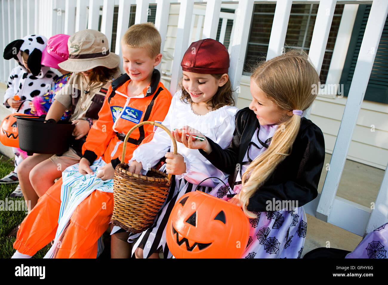 Group of neighborhood children on Halloween, having fun in costume ...