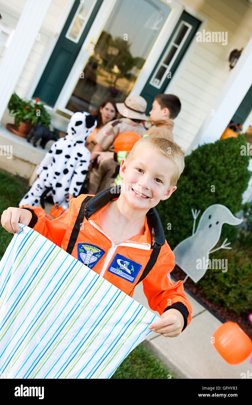 Group of neighborhood children on Halloween, having fun in costume ...