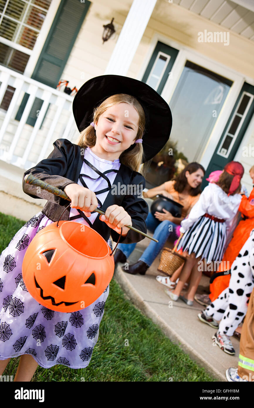 Group of neighborhood children on Halloween, having fun in costume ...