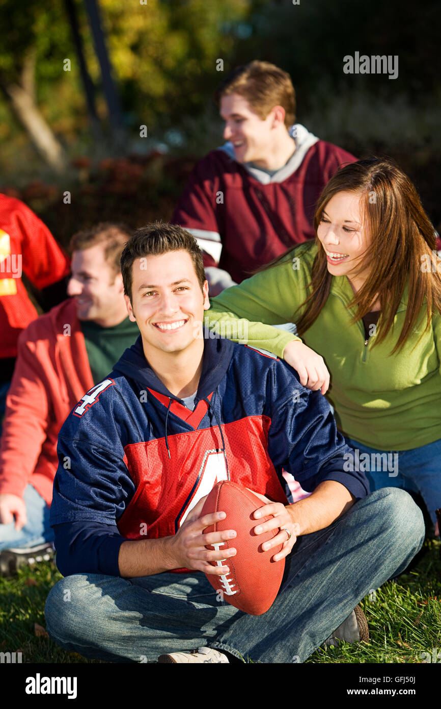 Series of a group of friends playing football in the park on an Autumn ...