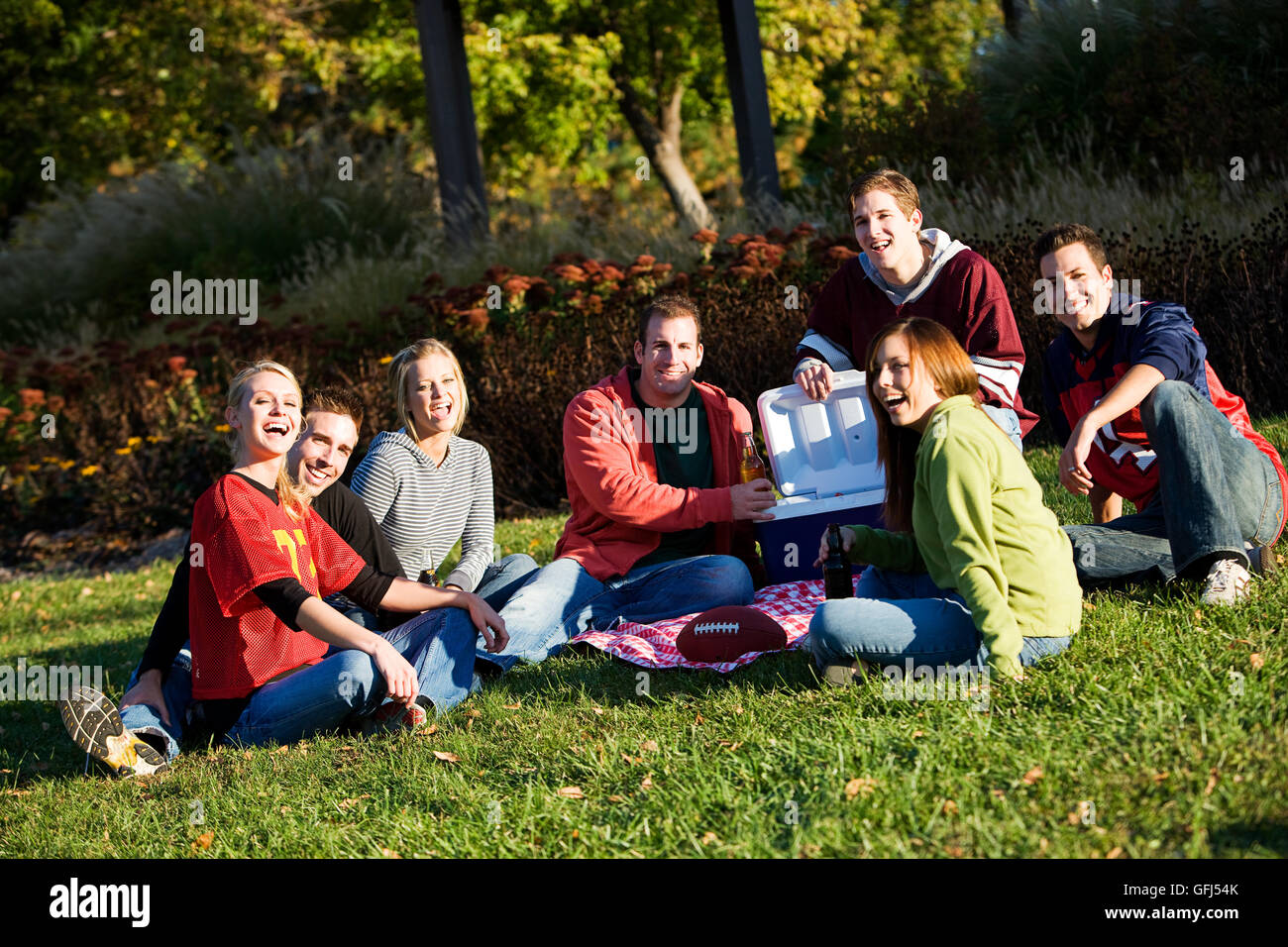 Series of a group of friends playing football in the park on an Autumn ...