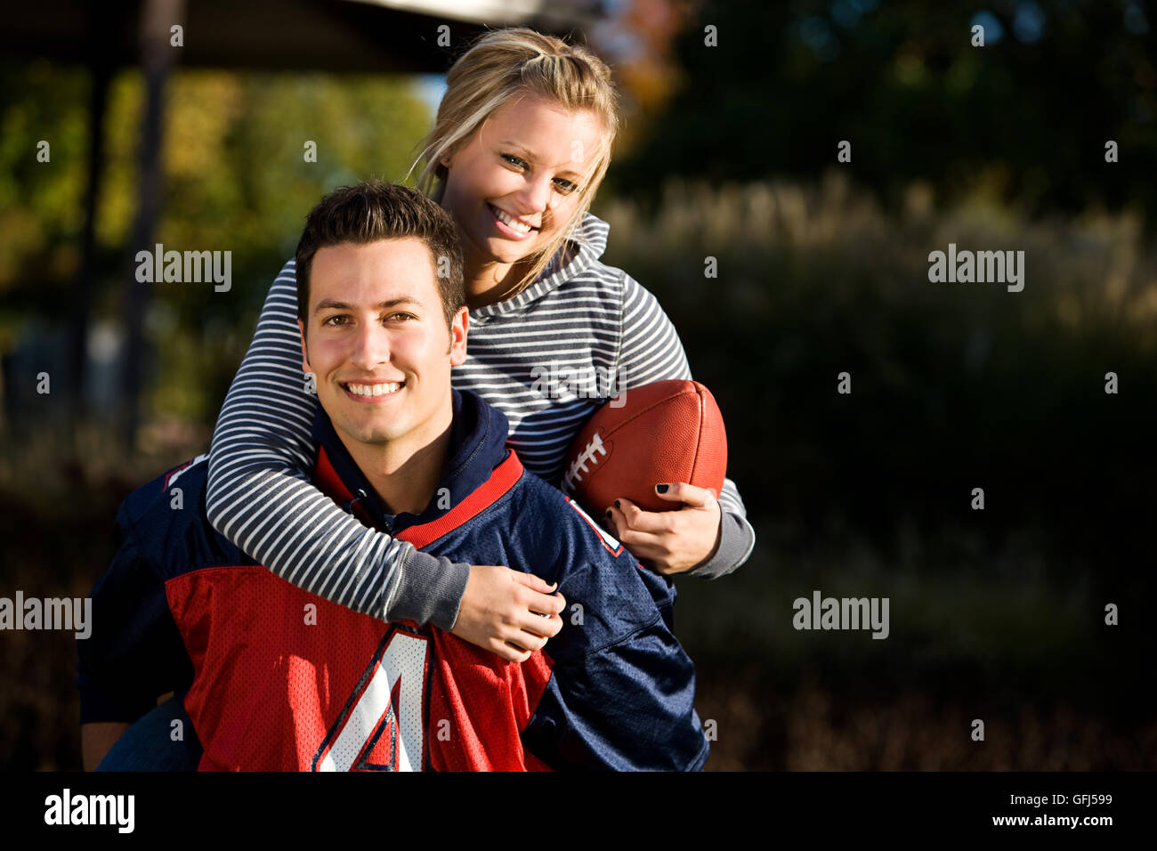 Series of a group of friends playing football in the park on an Autumn ...