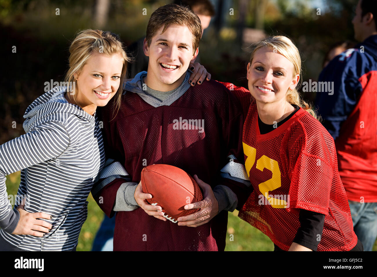 Series of a group of friends playing football in the park on an Autumn ...