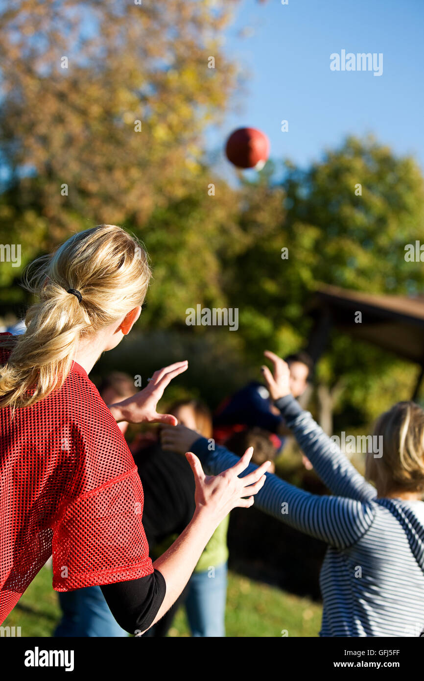 Series of a group of friends playing football in the park on an Autumn ...