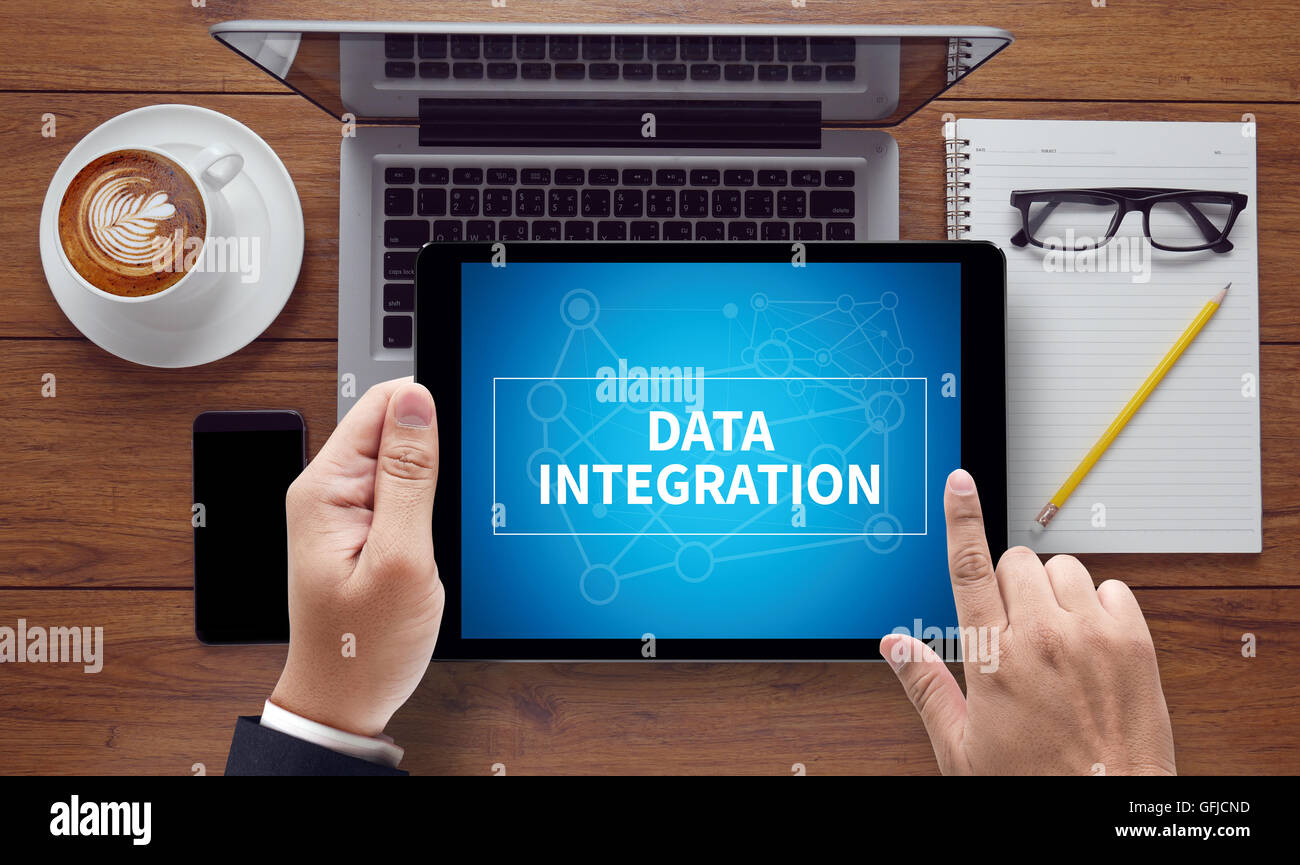 DATA INTEGRATION, on the tablet pc screen held by businessman hands ...