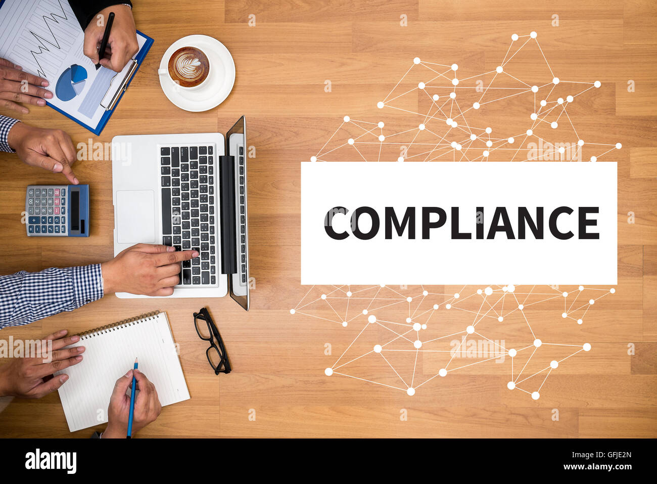 COMPLIANCE Business team hands at work with financial reports and a ...