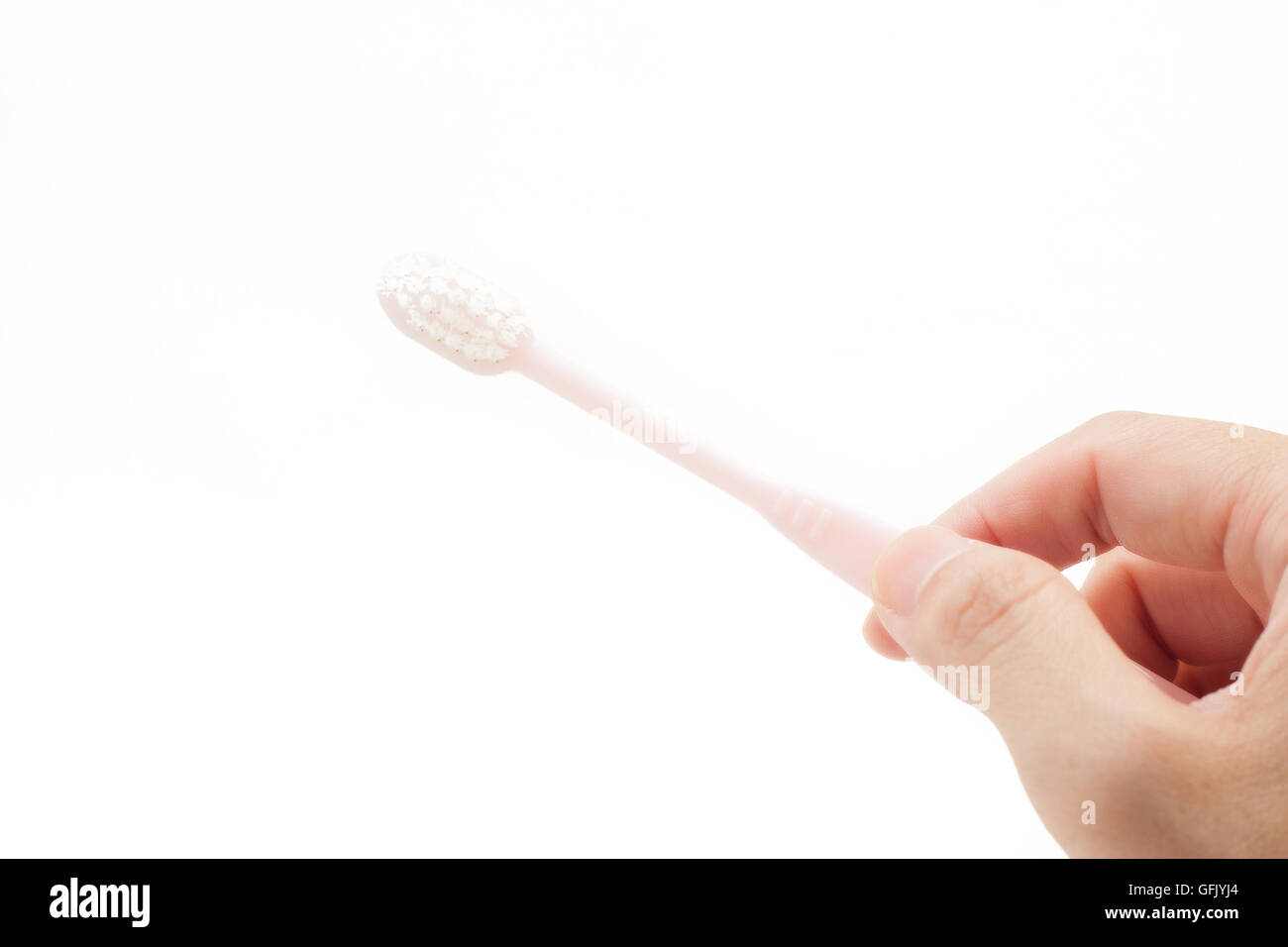 Holding a toothbrrush by hand on white isolated background Stock Photo ...